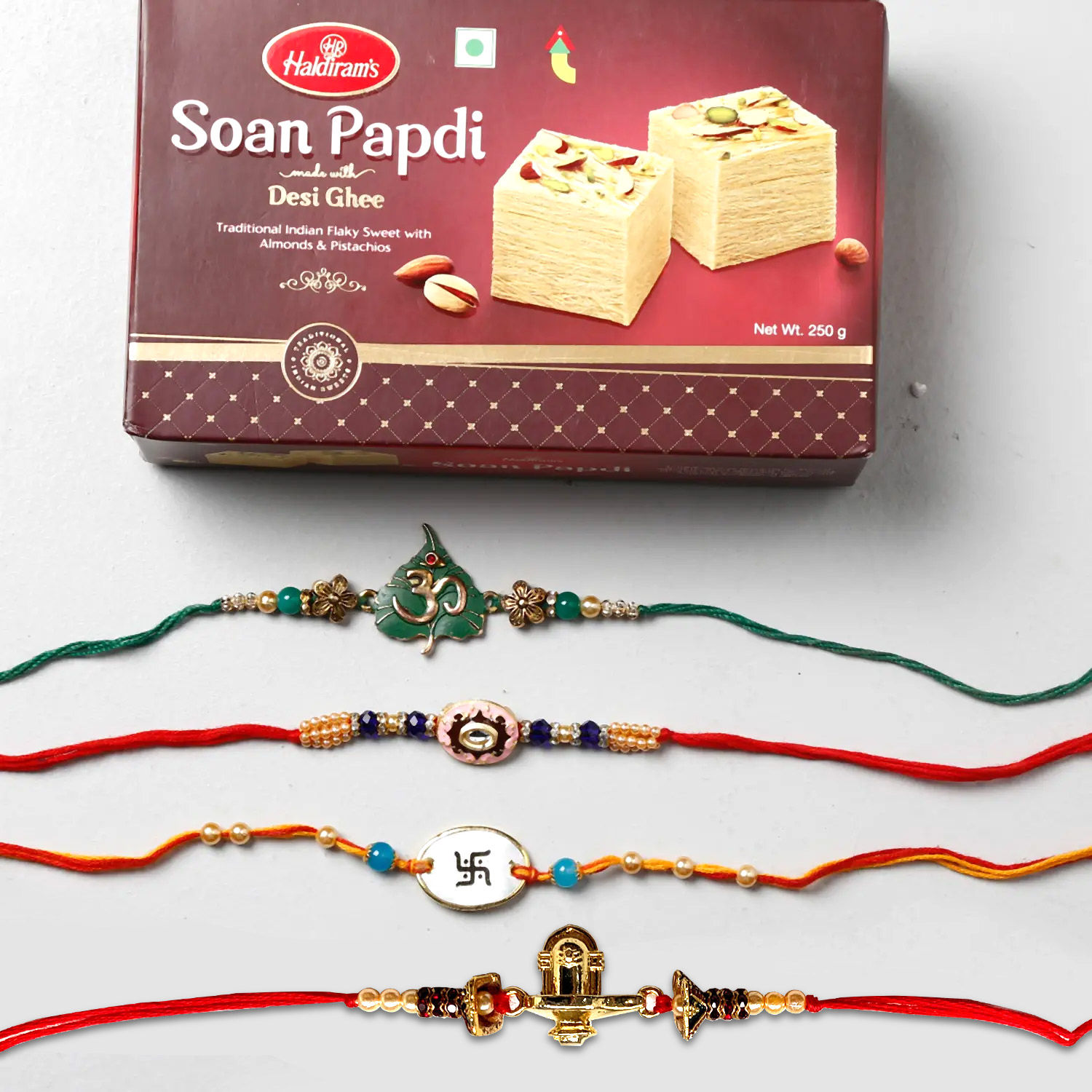 Order Set of 4 Spiritual Rakhis and Soan Papdi Online | Same-Day ...